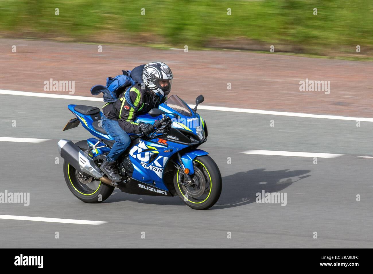 Team SUZUKI ECSTAR motorcycle; travelling at speed on the M6 motorway ...