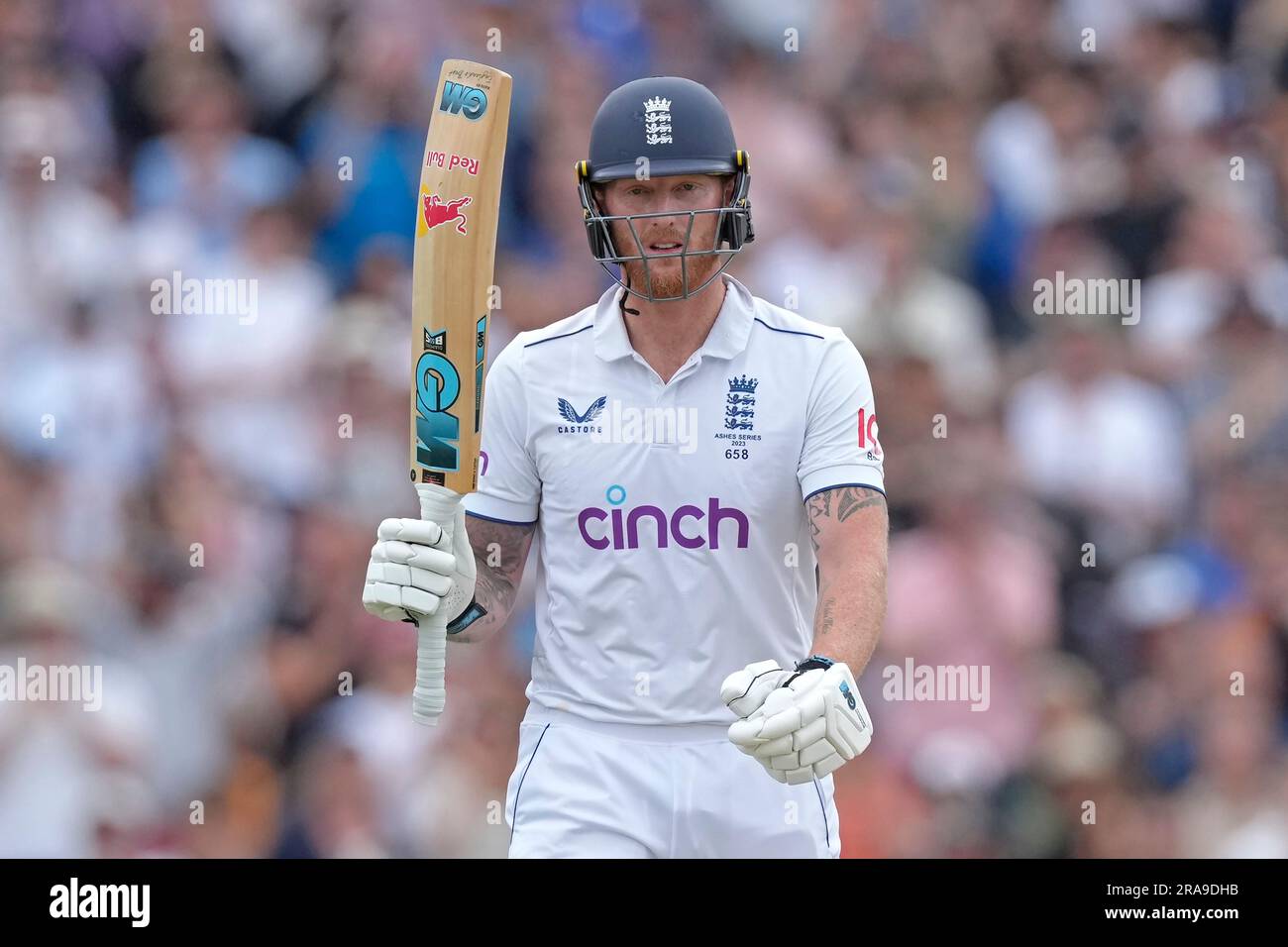 England's captain Ben Stokes raises his bat to celebrate scoring fifty ...