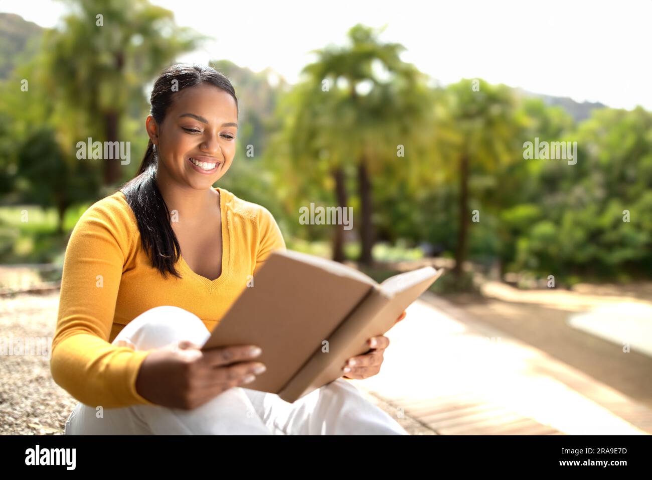 Woman Reading A Book Outside