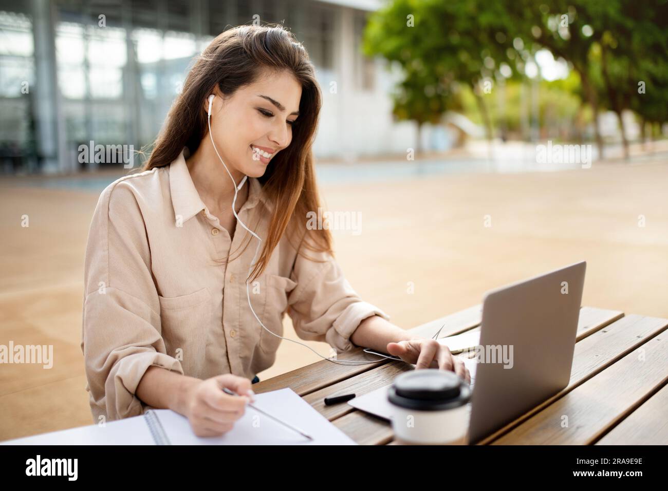 Happy student lady learning watching lecture online via laptop outdoor ...