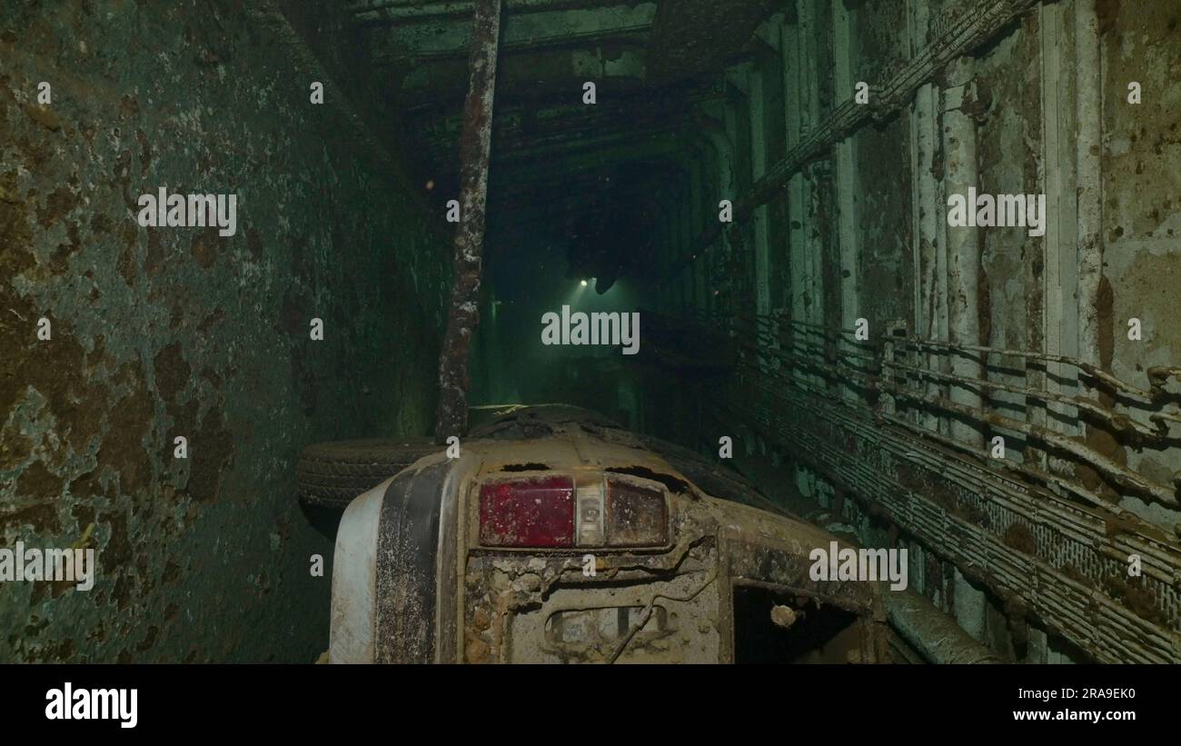 Scuba diver swim above car lying inside cramped hold of ferry Salem ...