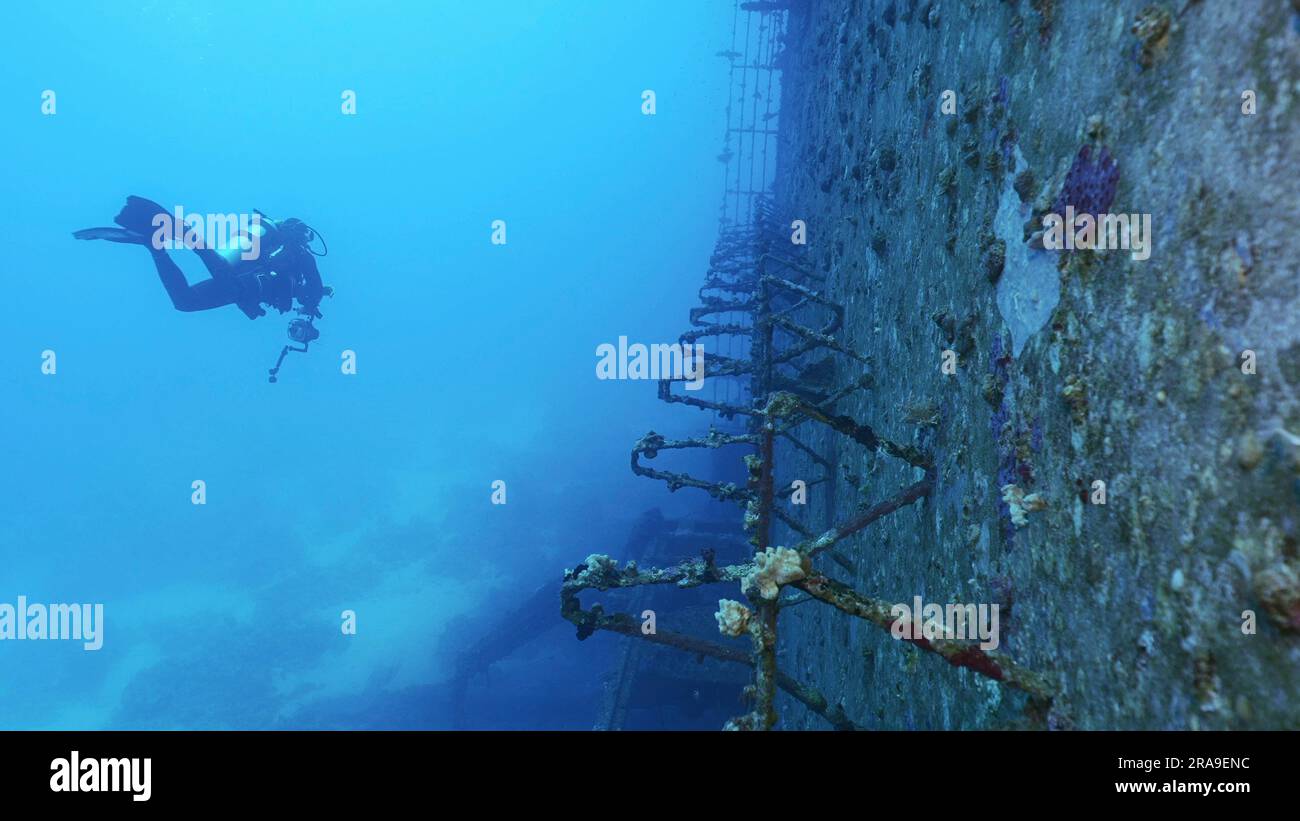 Scuba diver swim along deck of ferry Salem Express shipwreck ...