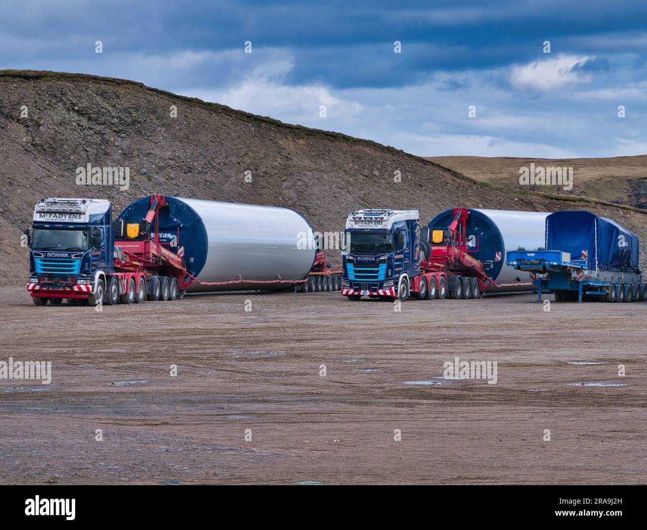 Lorries waiting to take wind turbine support tower sections to their ...