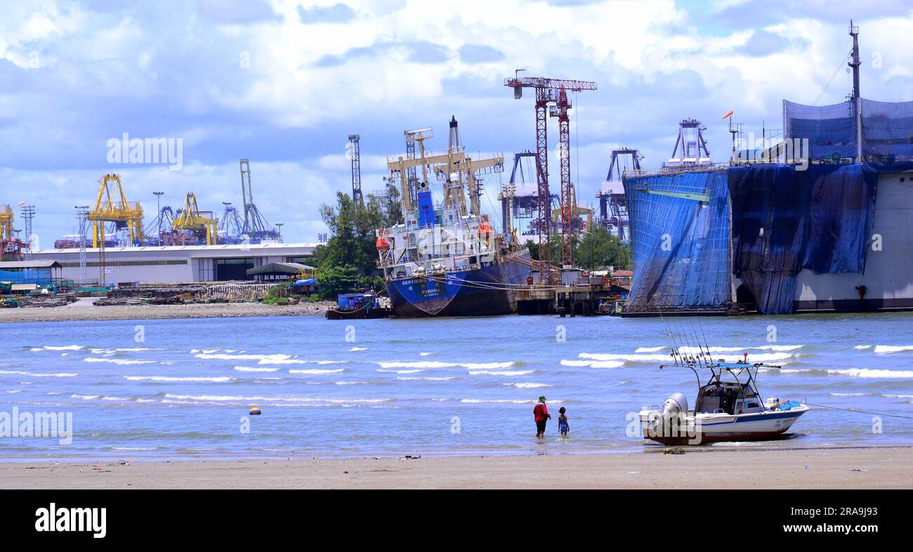People enjoy beach activities, like paddling in the shallow sea water ...