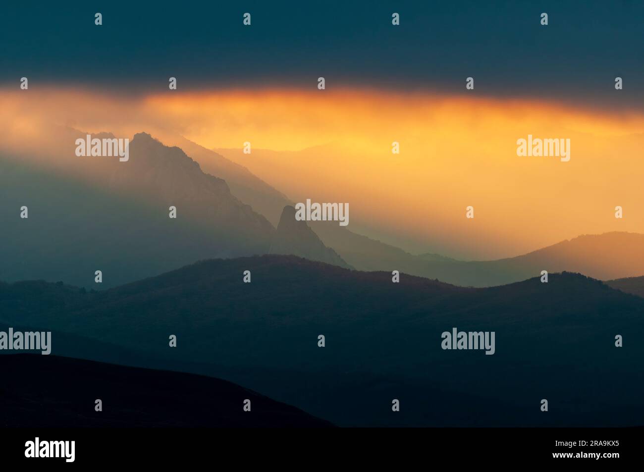 Amazing mountain landscape. Mountain peaks with dramatic low clouds and ...