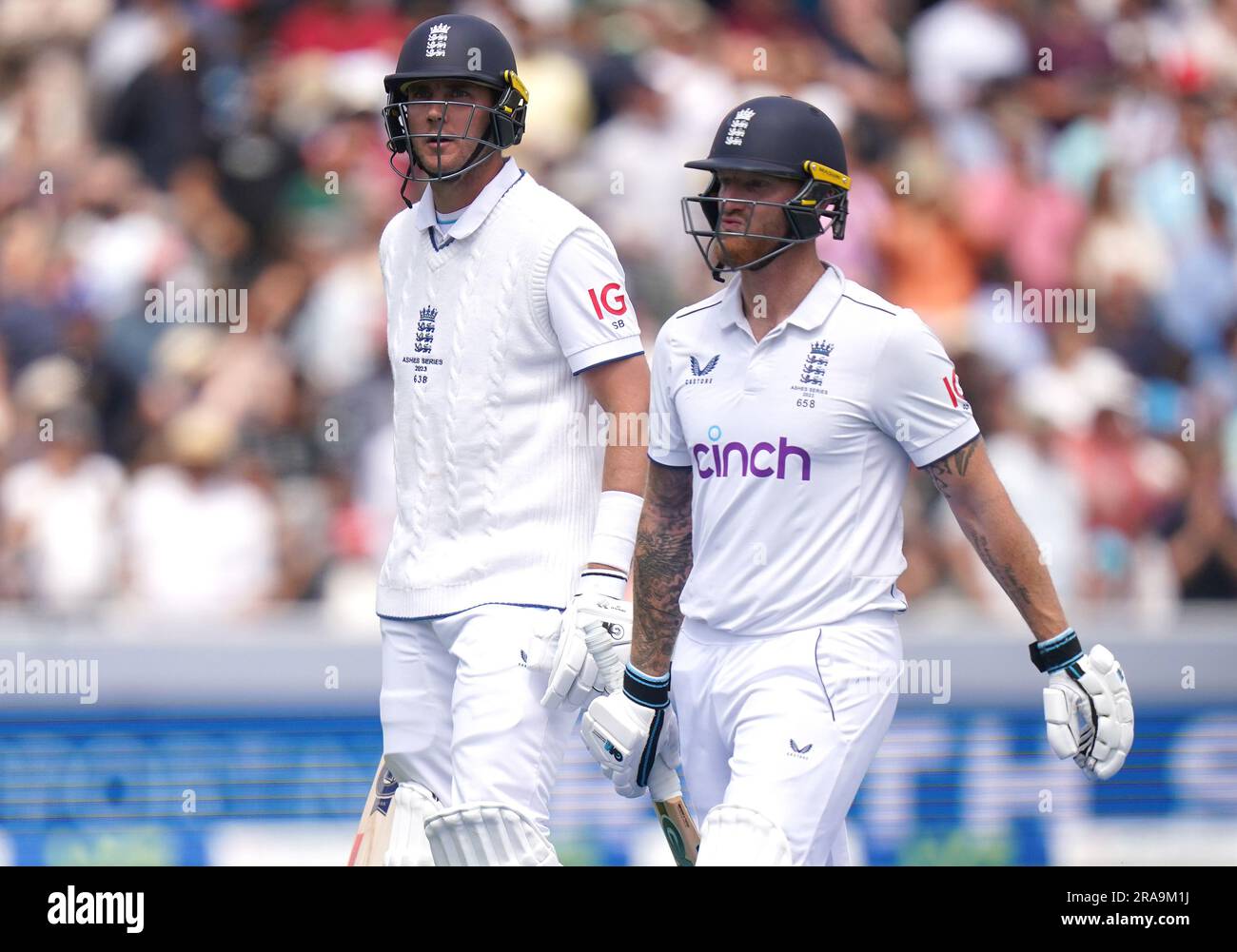England's Stuart Broad and Ben Stokes makes his way off the field for ...