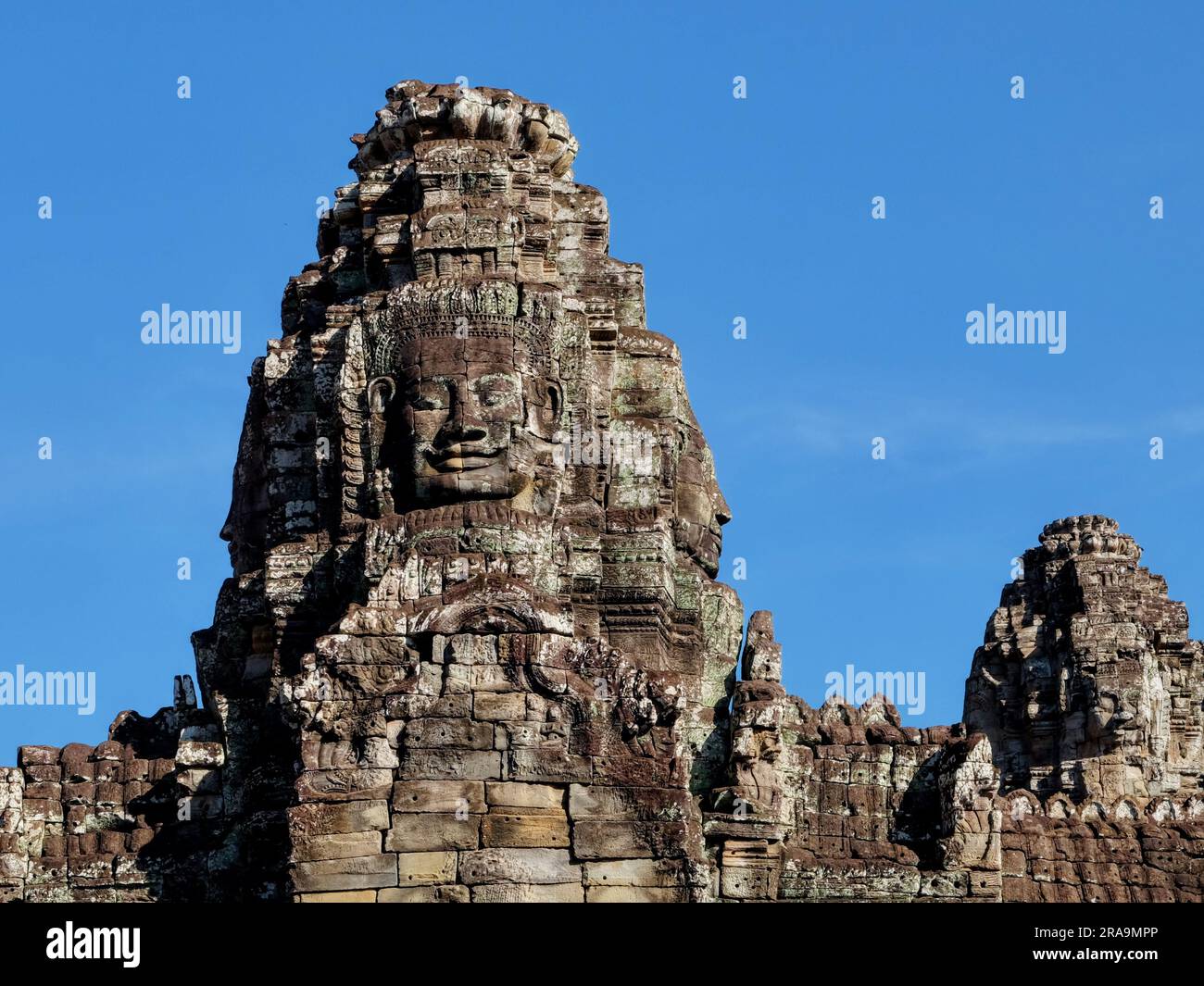 Stone human faces on the towers of the Khmer Bayon Temple Stock Photo ...