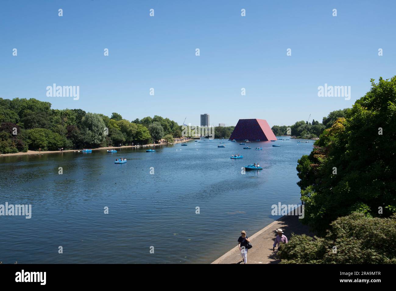 People in pedelos paddle past The London Mastaba - a floating sculpture ...