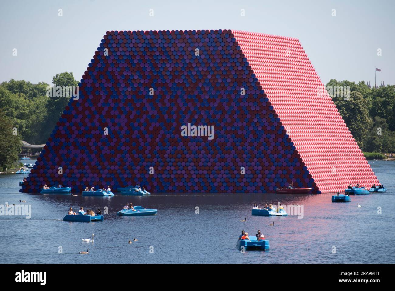 People in pedelos paddle past The London Mastaba - a floating sculpture ...