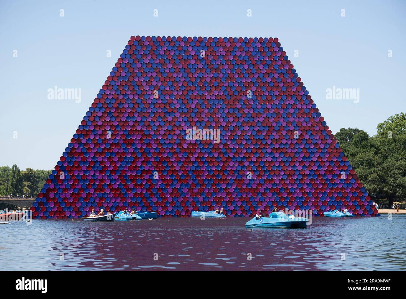 People in pedelos paddle past The London Mastaba - a floating sculpture ...