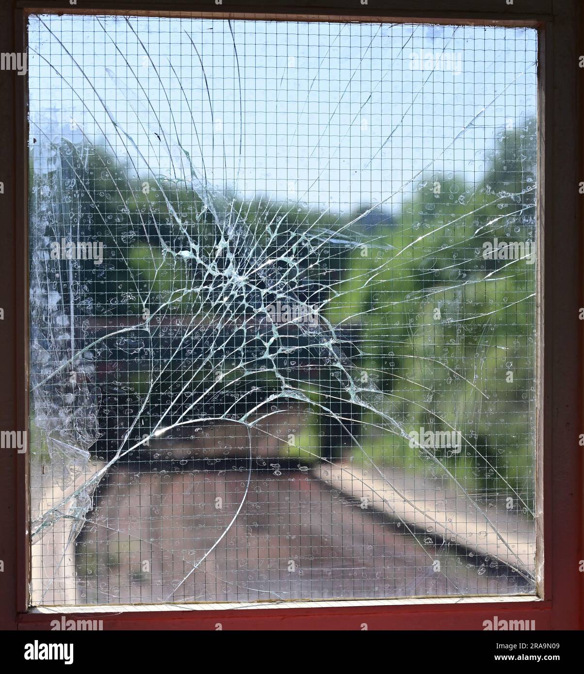 A broken window seen from the inside Stock Photo - Alamy