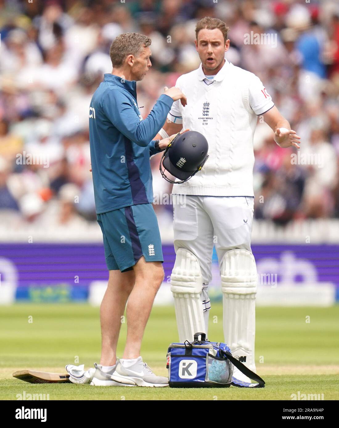England's Stuart Broad (right) is accessed by medical staff after being ...