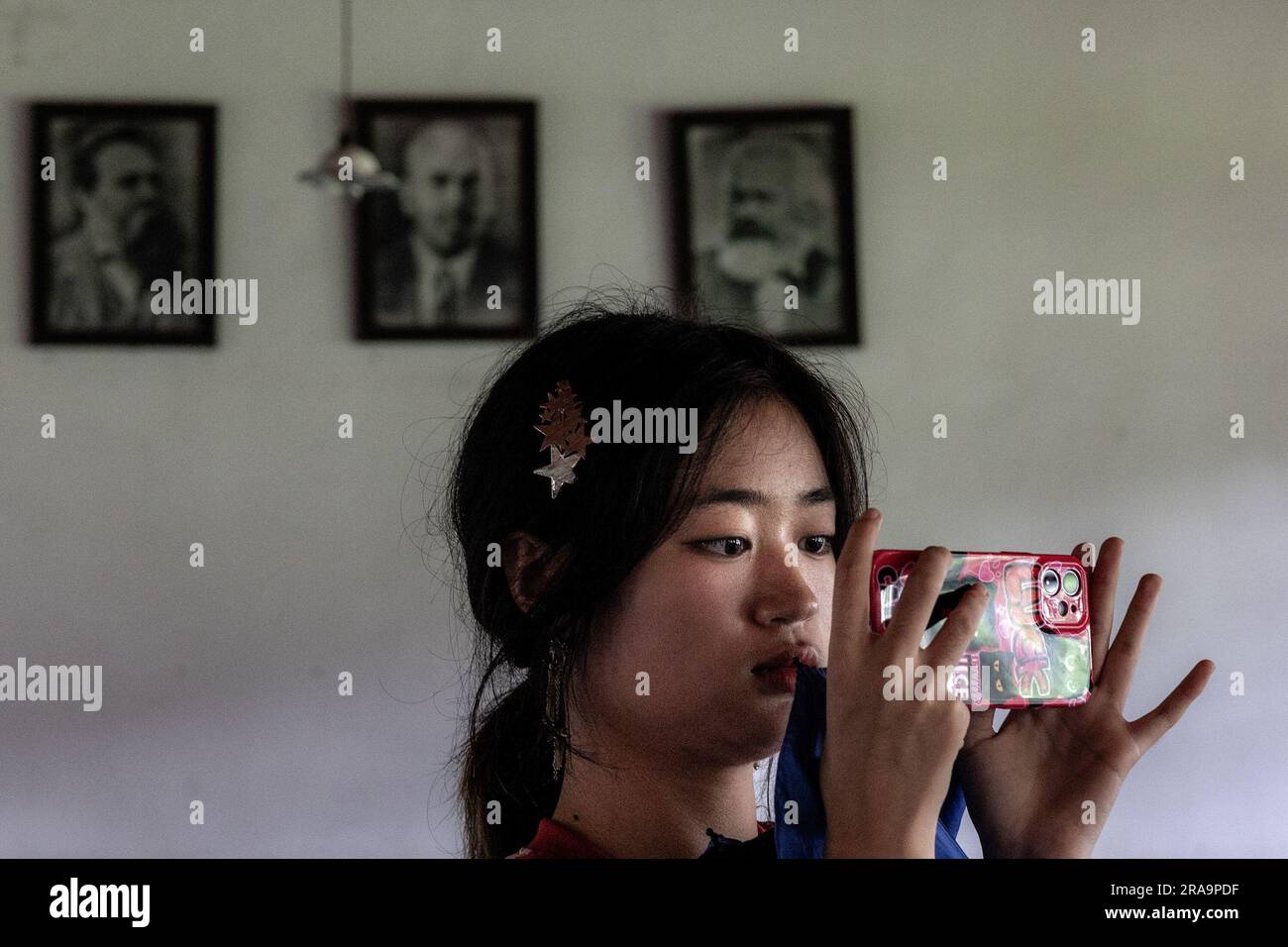 Wuhan, China. 01st July, 2023. A college student takes photos in front ...