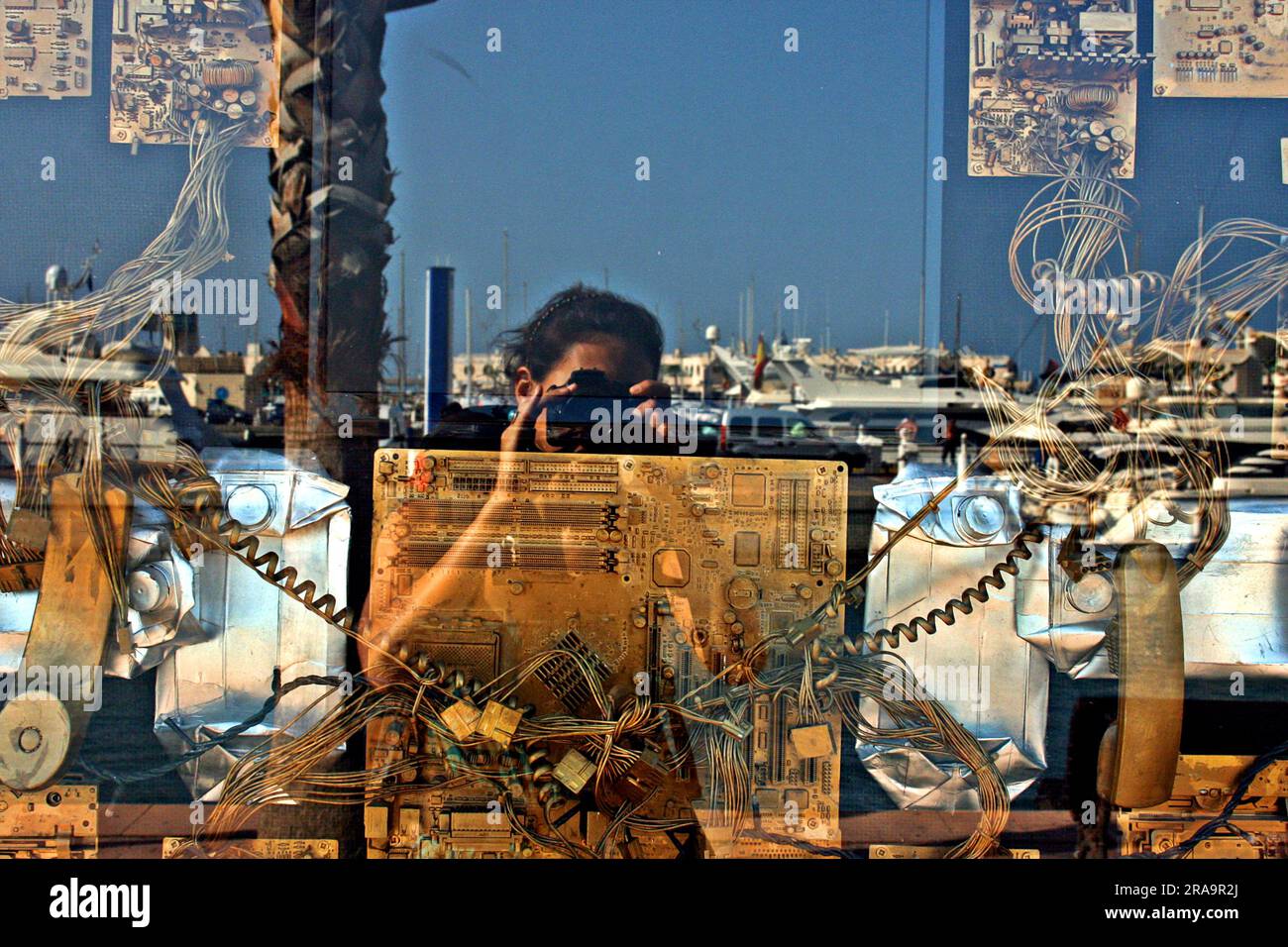 Reflection in a shop window display at a spanish harbour showing ...