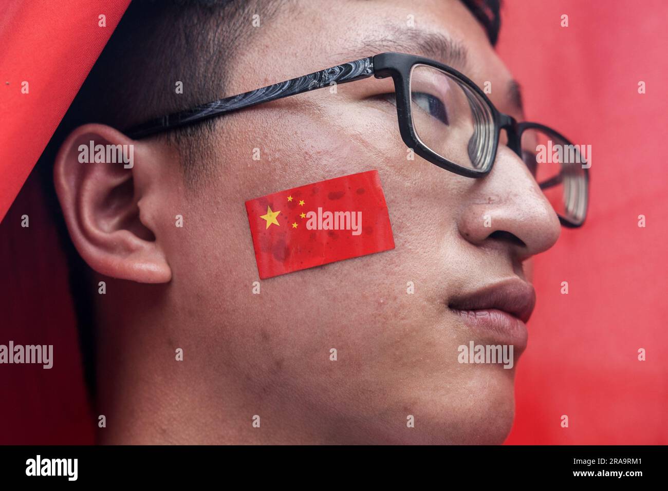 Wuhan, China. 01st July, 2023. A man seen with a Chinese flag painted ...