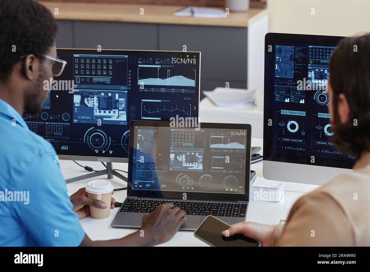 Focus on laptop with statistic graphic data on screen and young African ...