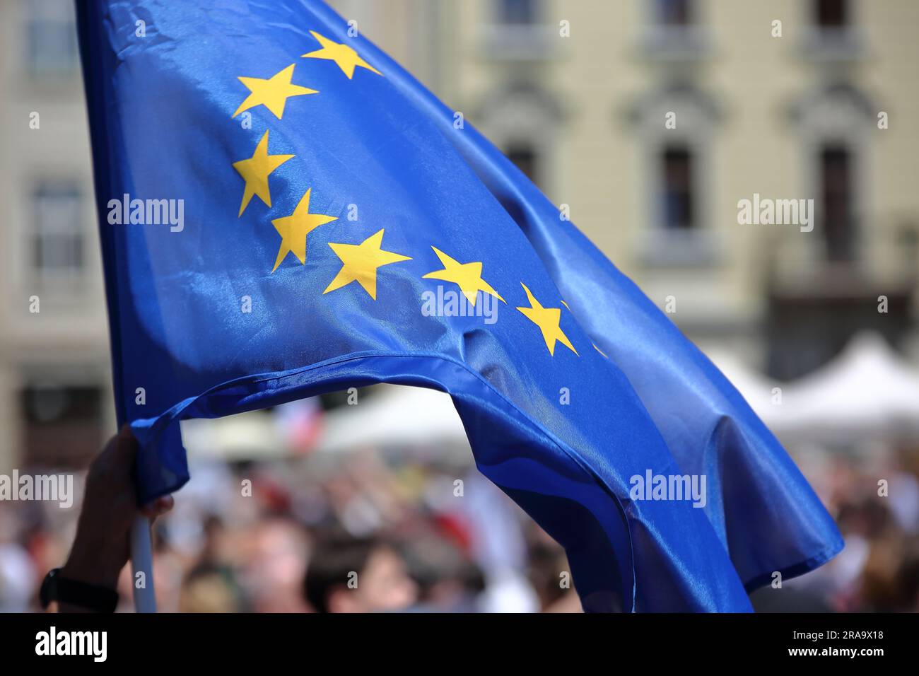 Big blue flag with yellow stars symbolizing European Union in human ...
