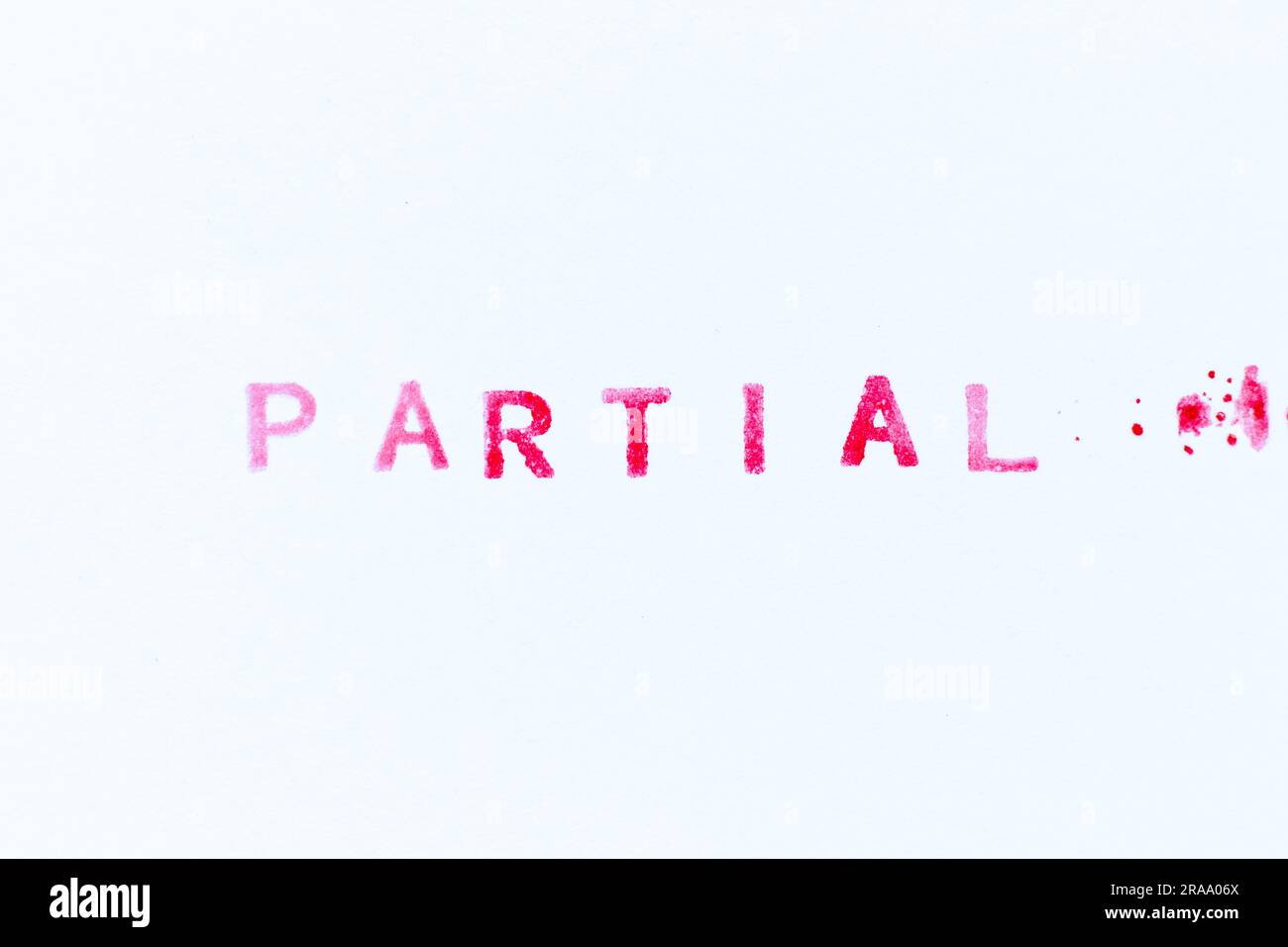 Red color ink rubber stamp in word partial on white paper background ...