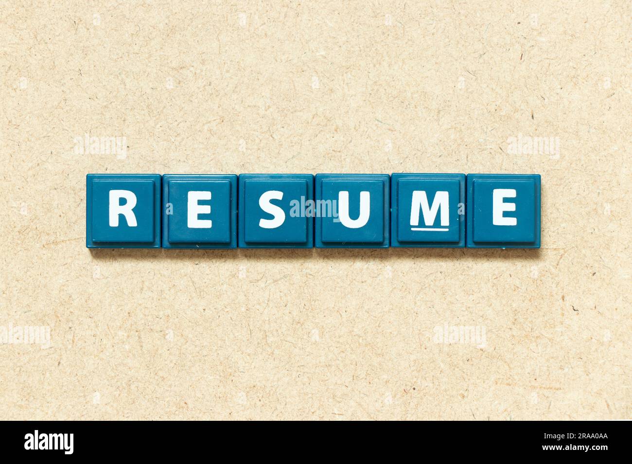 Tile alphabet letter in word resume on wood background Stock Photo - Alamy