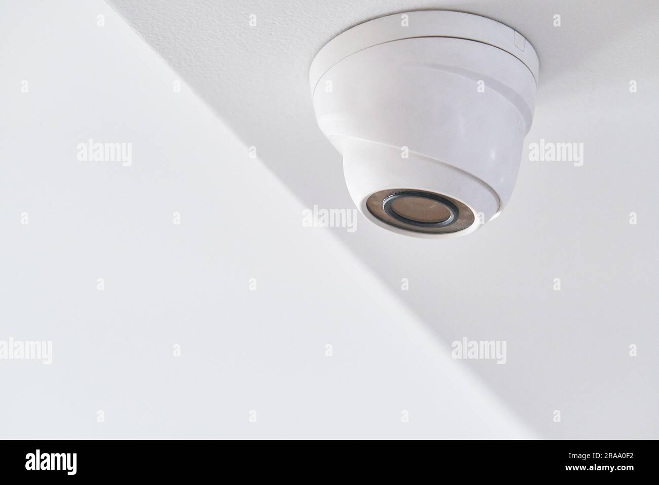 Cctv on white ceiling in modern building Stock Photo - Alamy