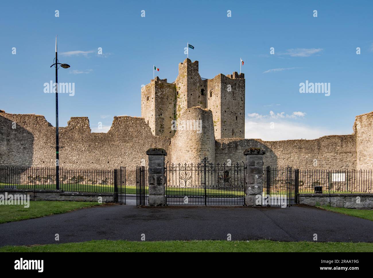 Flags flying at Trim Castle located across the road from the gates to ...