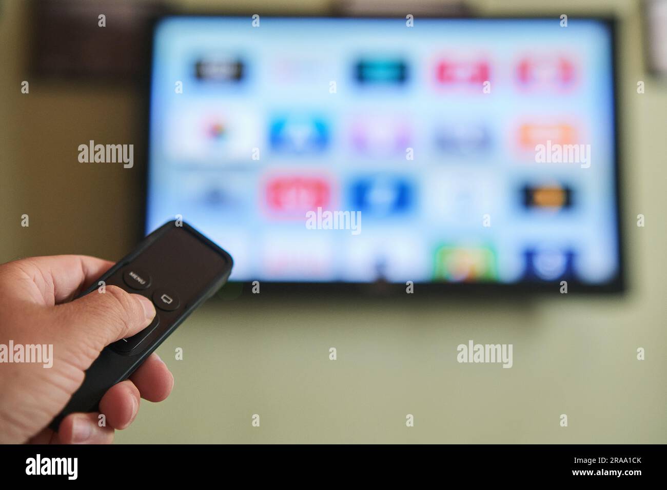 Multimedia streaming concept. Hand holding remote control. TV screen ...