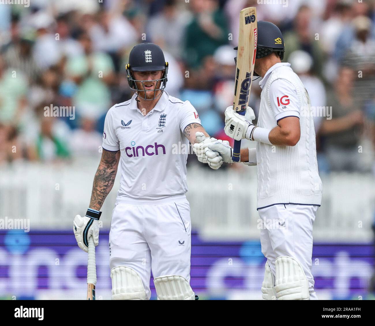 Stuart Broad of England fist bumps Ben Stokes of England as they notch ...