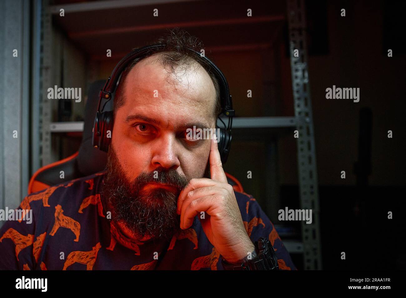 Portrait of an adult male with a beard, works in front of a computer ...