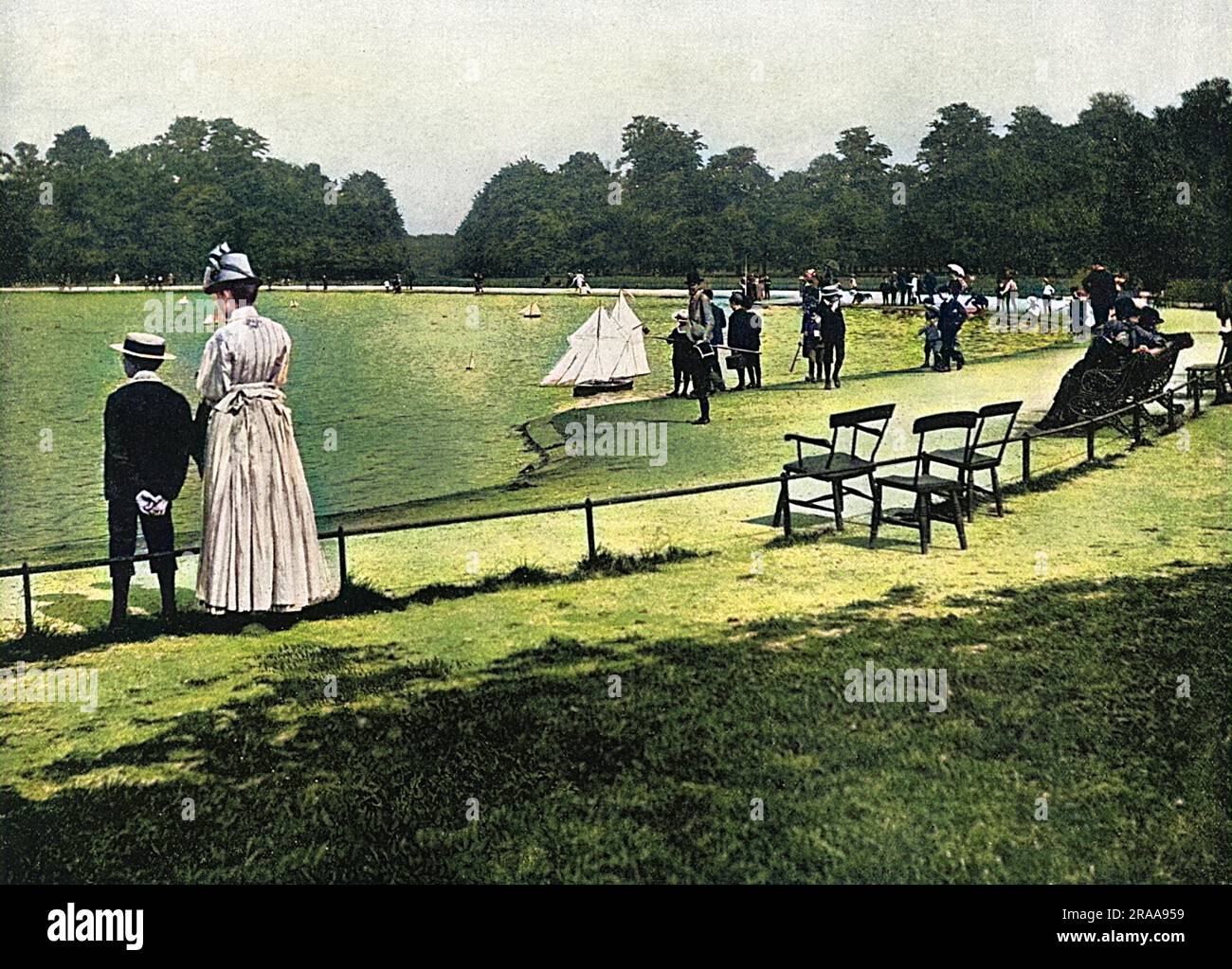 Sailing model boats on the Round Pond in Kensington Gardens. Date: 1896 ...
