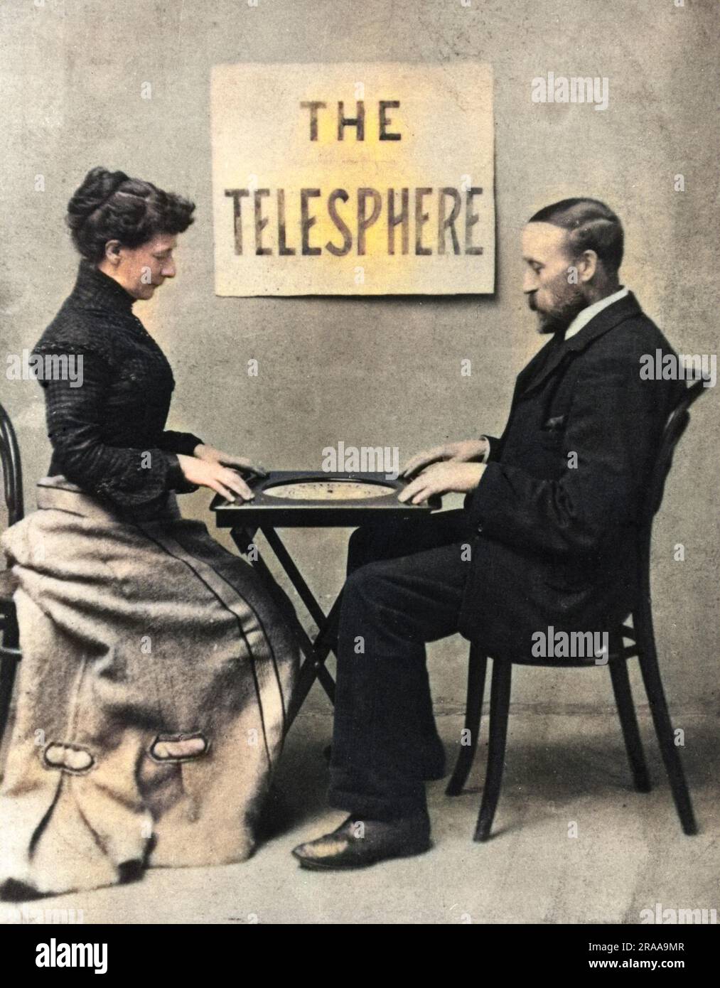 A couple using a Telesphere, a form of planchette or ouija board. Date ...