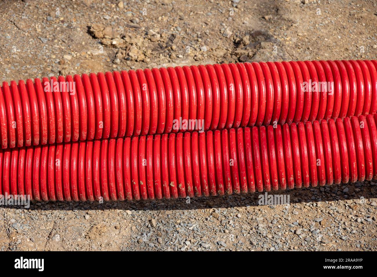 Red plumbing pipe close-up. Drainage, tubing, pipes. Red pipes of the water supply and heating ...
