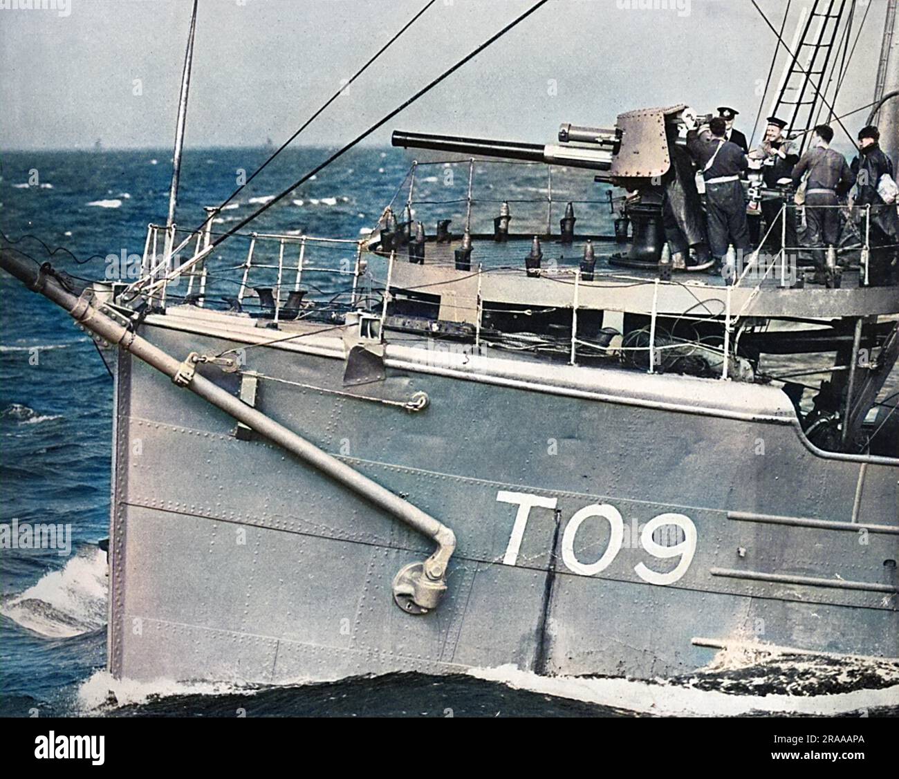Gun crew on the circular table of a British naval minesweeper going ...