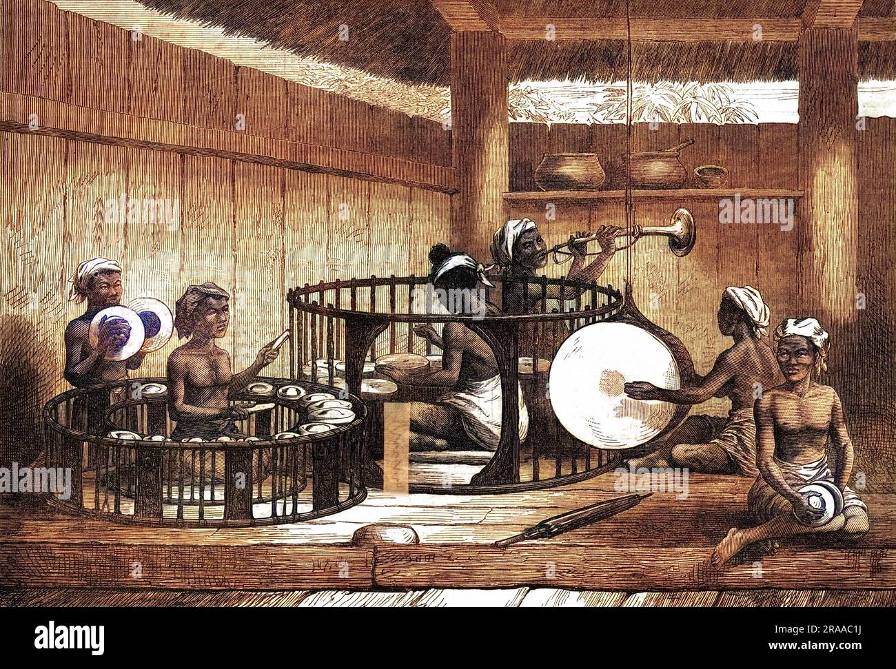 Burmese musicians make music indoors, 1872. A kong thom(or Khong Yai ...