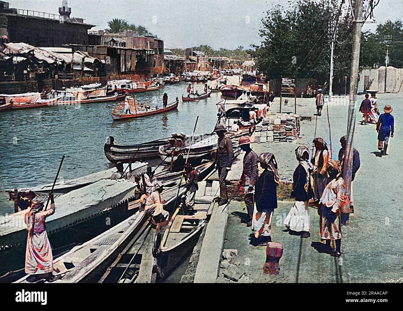 A view of the creek at Basra, showing British soldiers hiring a ballam ...