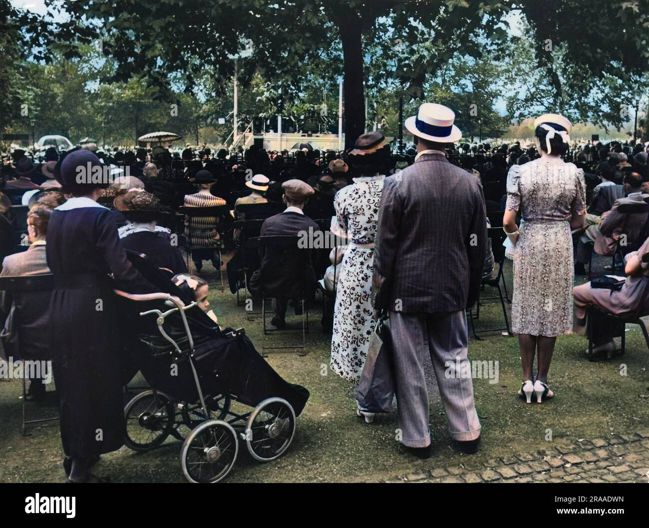 An audience in a London park enjoy the music of a brass band playing on ...