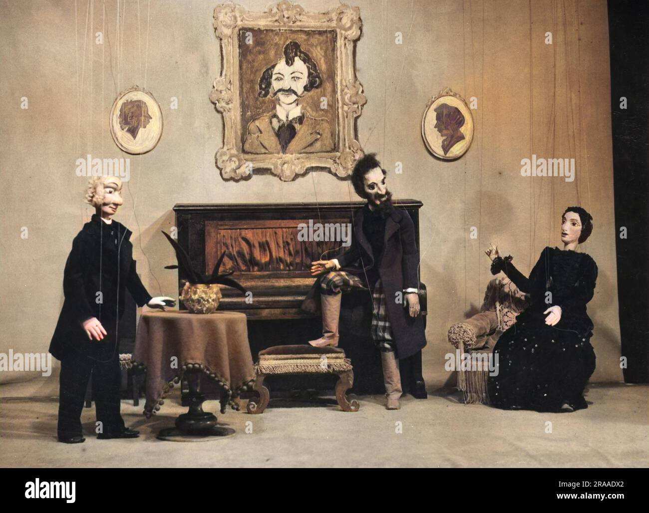 Three Victorian puppets on a miniature stage, with all the props ...