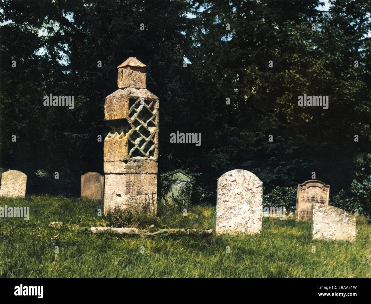 An ancient sundial among the gravestones in the churchyard of Elmley ...