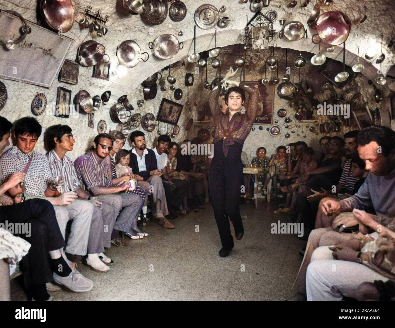 Tourists watching a male gypsy dancer dancing in a taverna in Spain ...