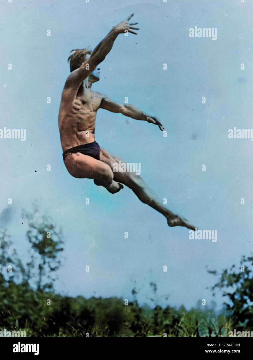 A muscular German athlete flies through the air. Date: 1930s Stock ...