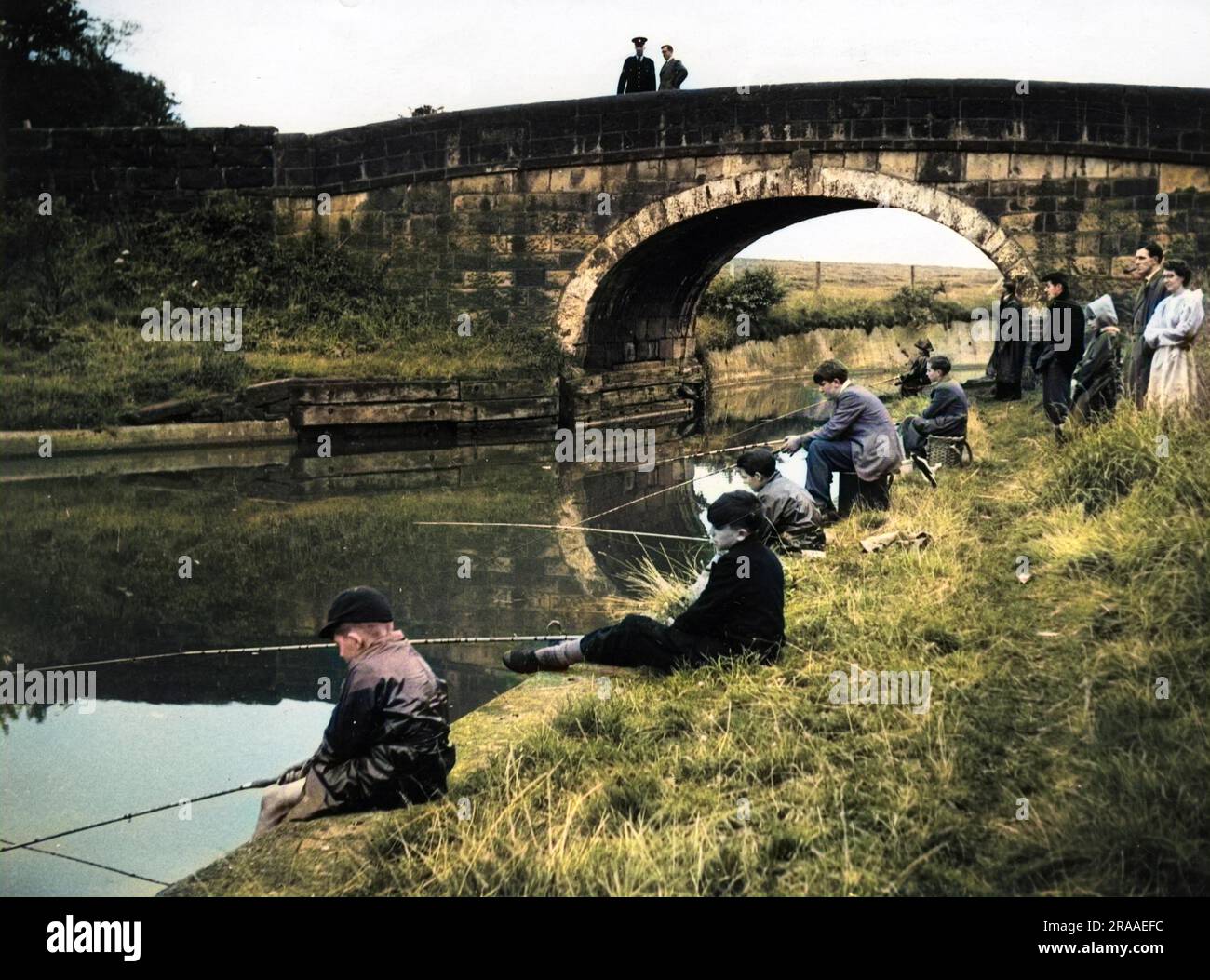 Schoolboy anglers, fishing on a canal bank in Lancashire, England. Date ...