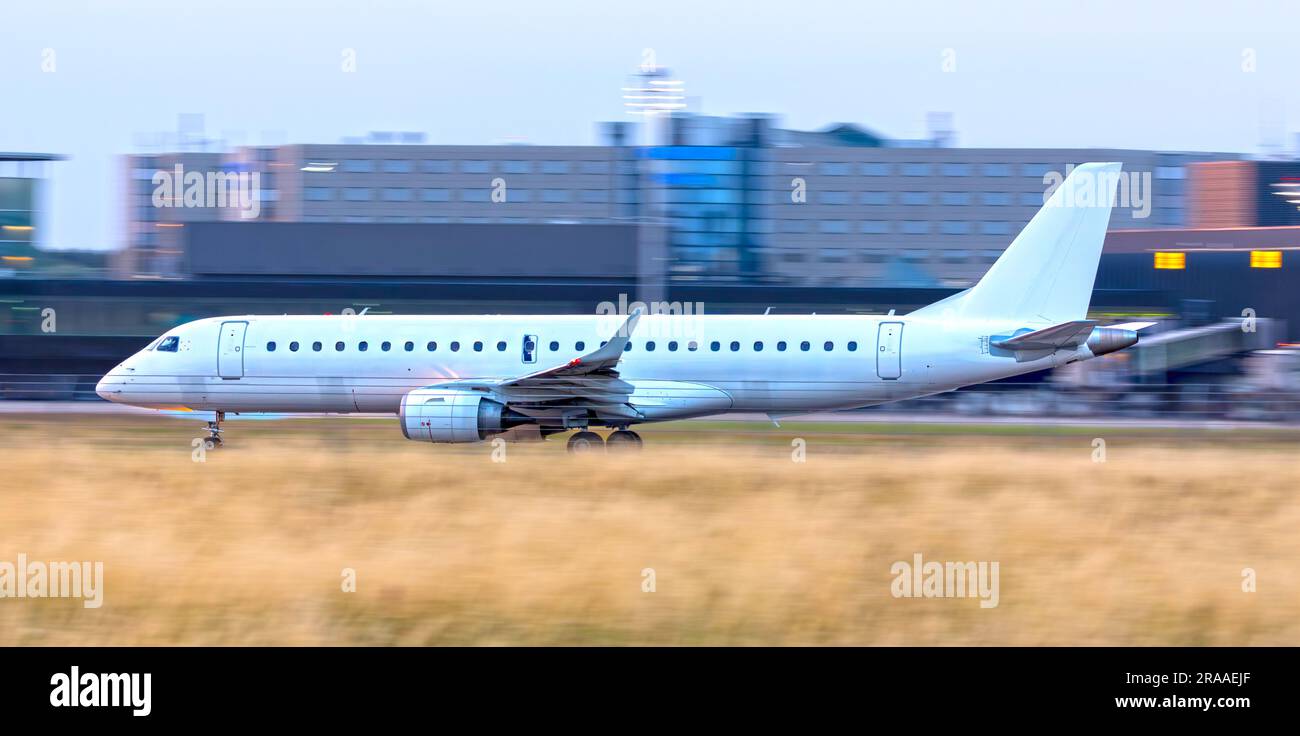 white new passenger airplane taking off from runway without logo with ...