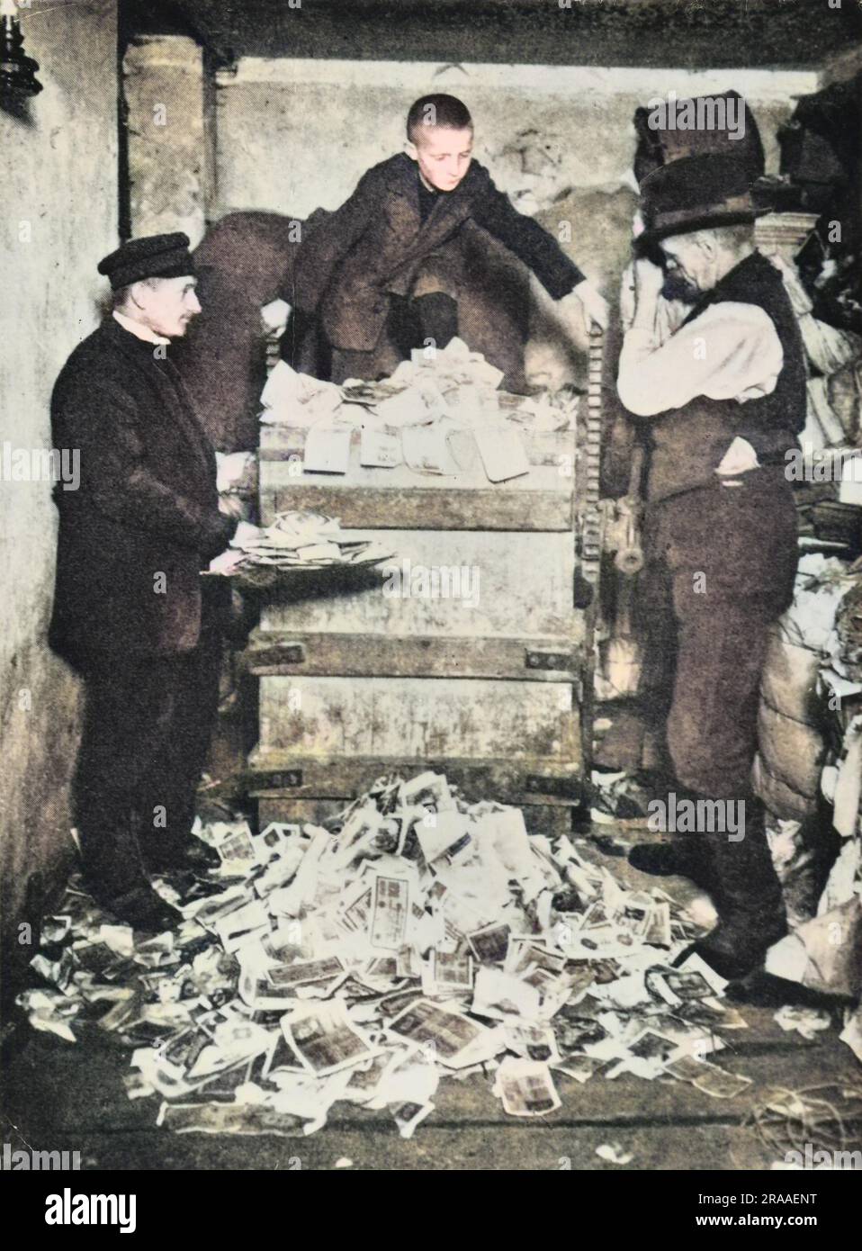 A boy and men with a pile of useless Deutsch mark banknotes as ...