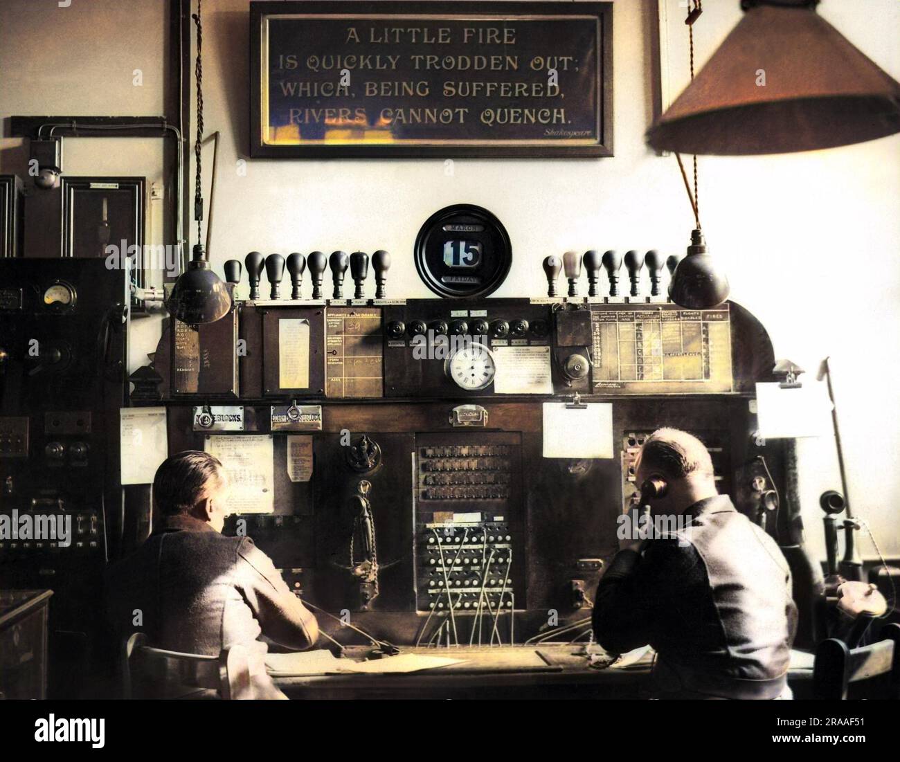 Firefighters working on the watchroom telephone switchboard at ...