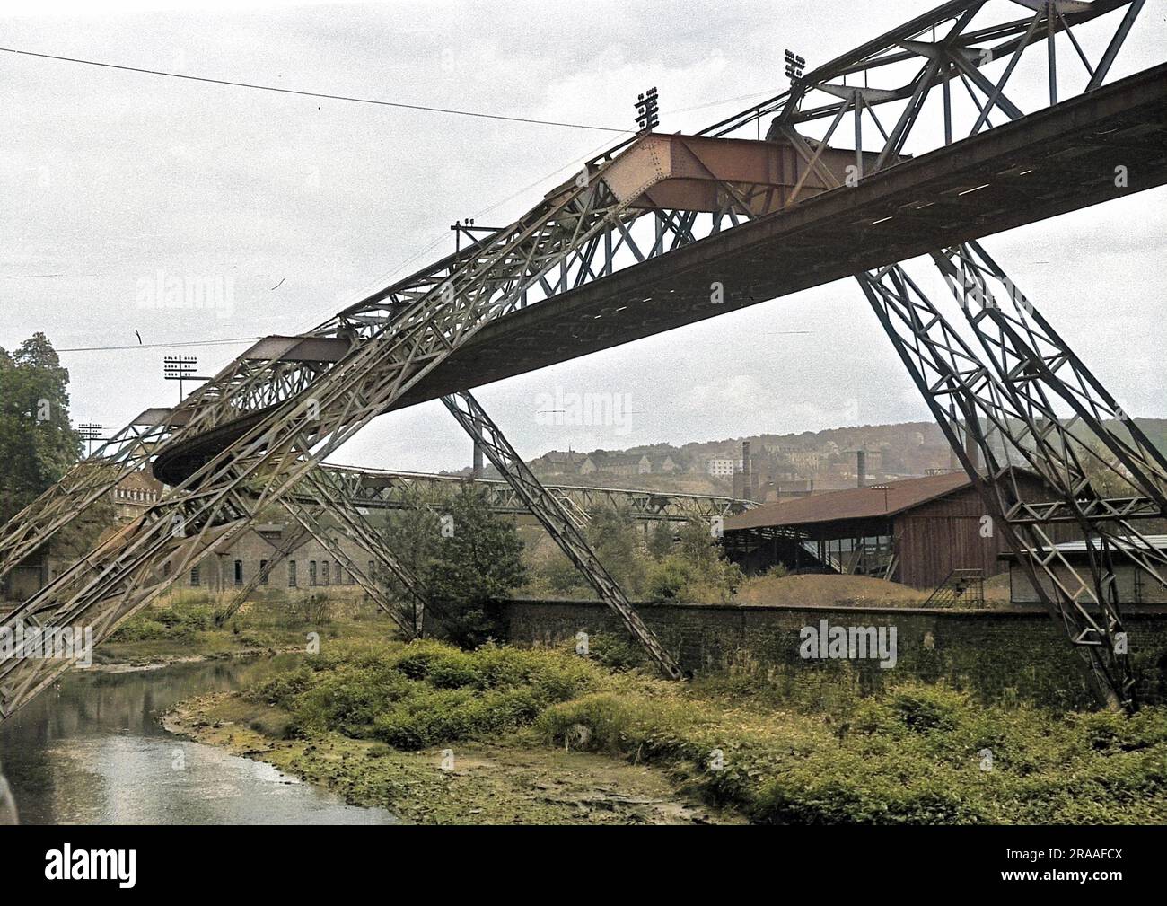 A large metal bridge structure over a river. Date: circa 1940s Stock ...