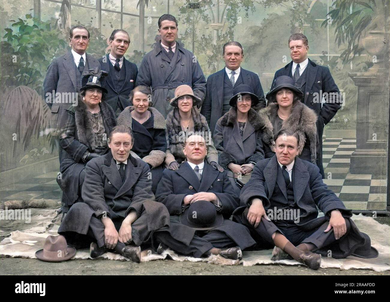 A group photo of men and women taken in a photographer's studio using a ...