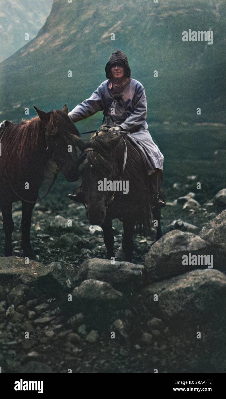 Woman out riding with two ponies on a rainy day in Portree, Isle of ...