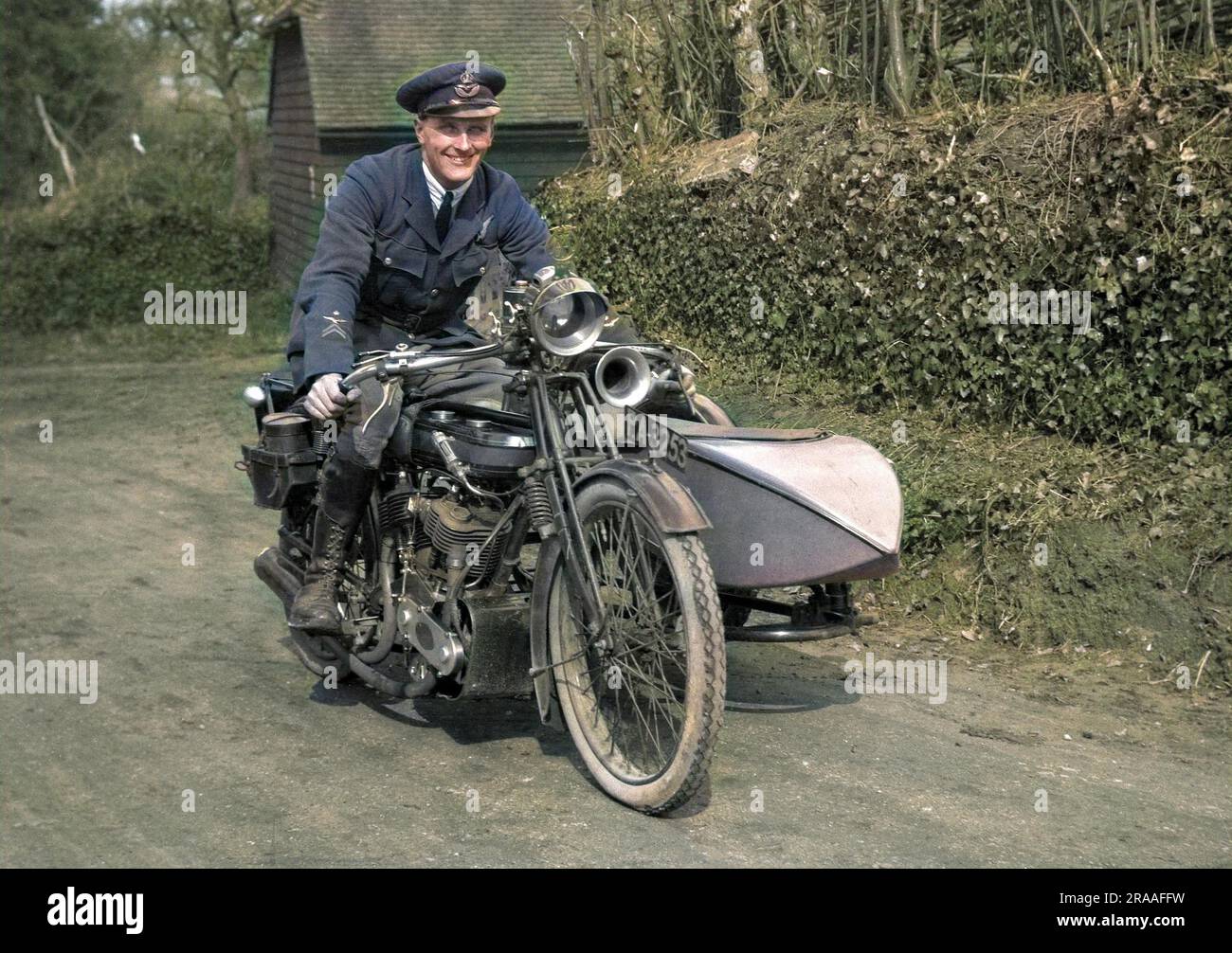 A man in RAF uniform riding a motorbike with a sidecar attached Stock ...