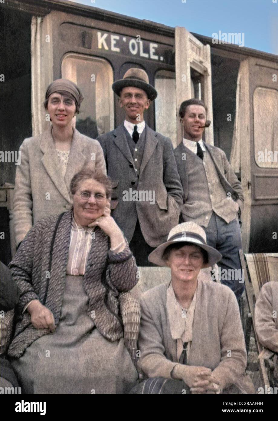 A group of five smiling holidaymakers. They appear to be in front of a ...