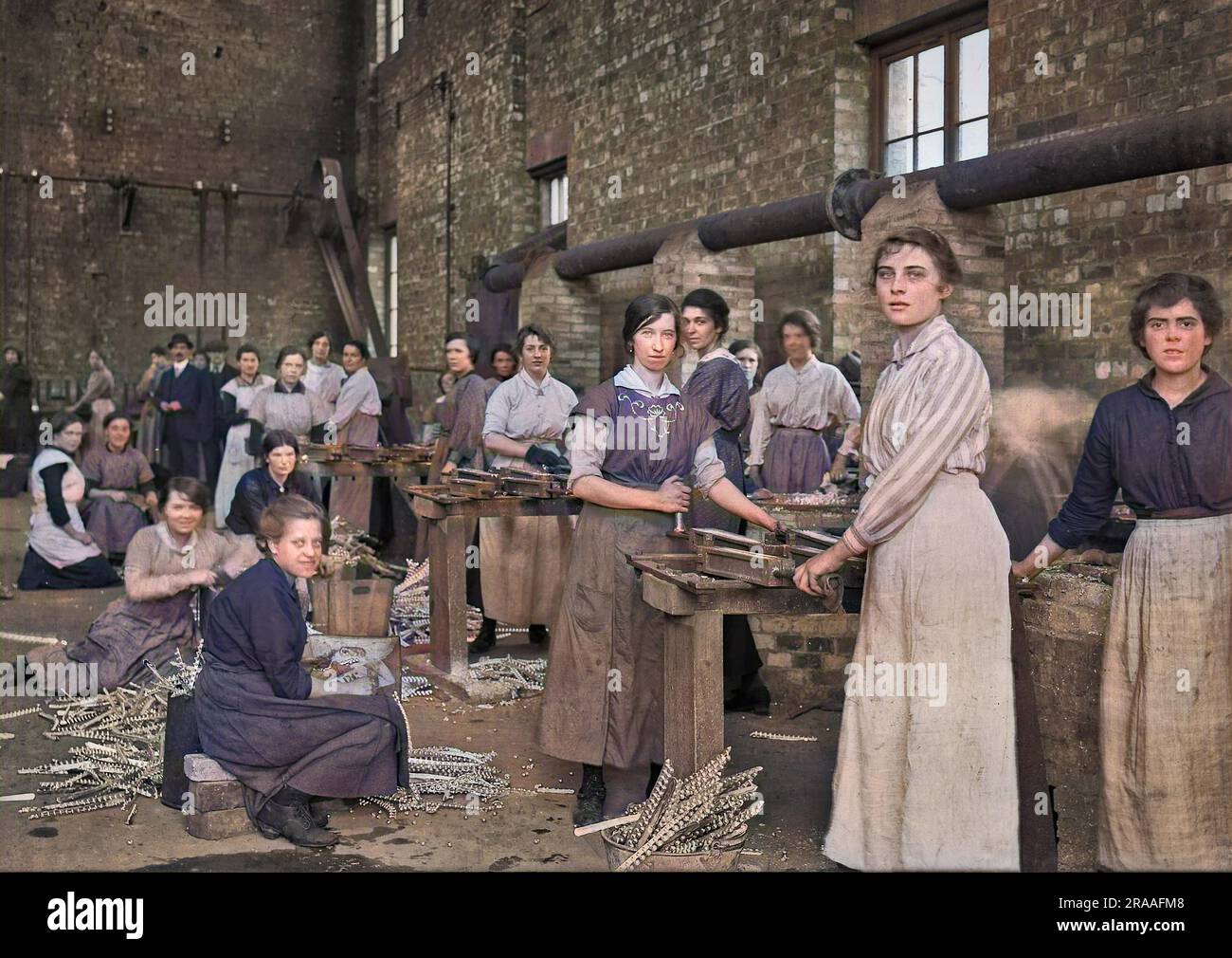 A group of manual workers, mostly women, inside a factory - WW1 era ...