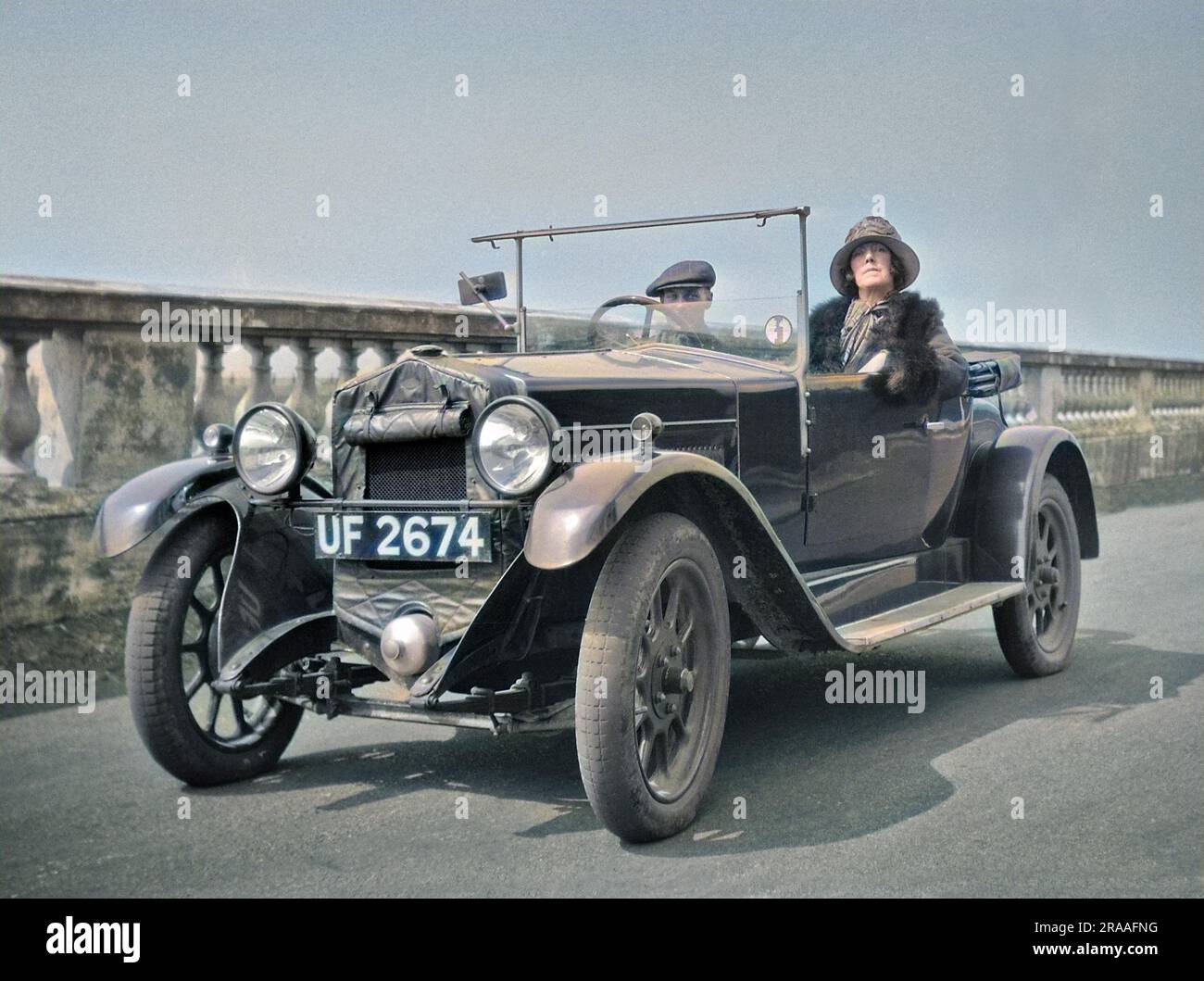 Couple in an open-topped car Stock Photo - Alamy
